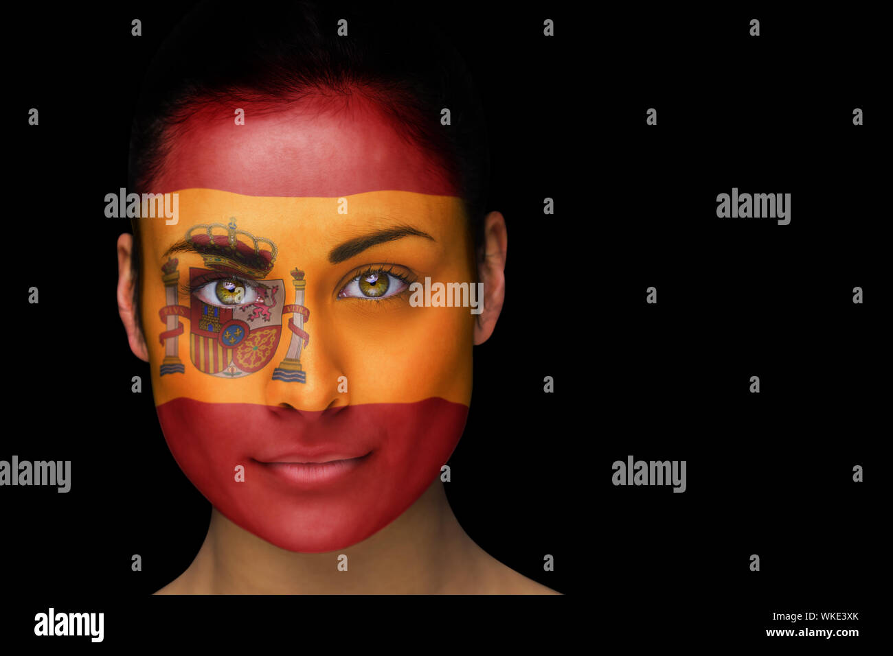 Composite image of spanish football fan in face paint against black ...