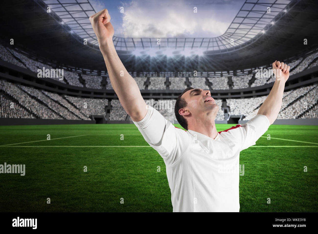 Excited football fan cheering in a vast football stadium with fans in ...