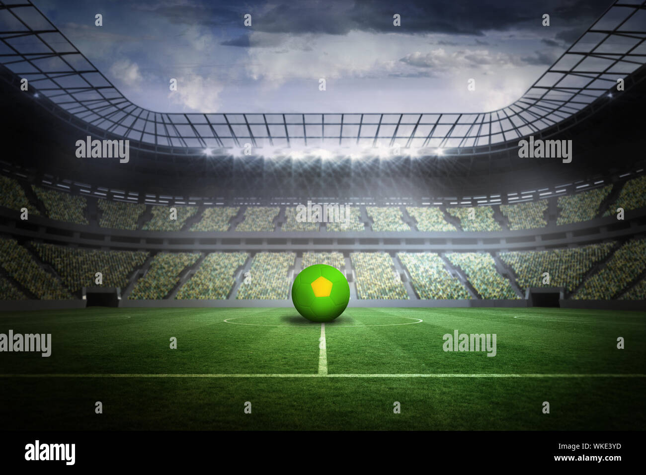 Bright green and yellow football in a large football stadium with fans ...