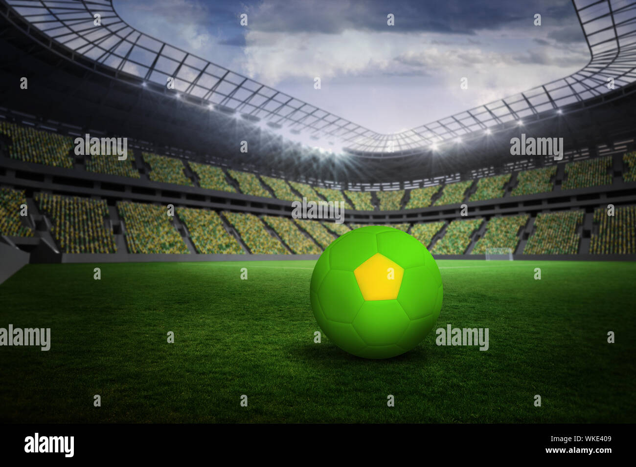 Bright green and yellow football in a large football stadium with fans ...