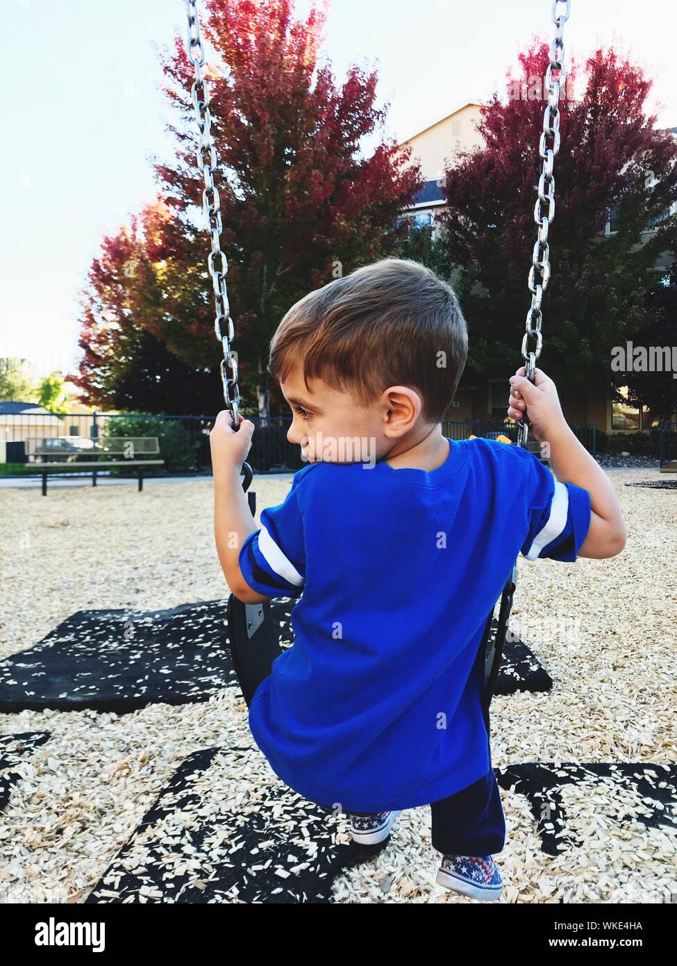 Boy playing swing hi-res stock photography and images - Alamy