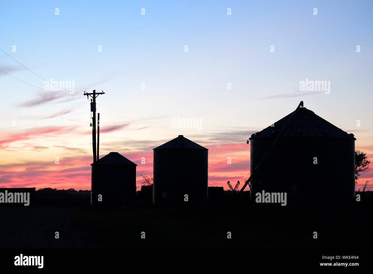 Silhouette of grain silo at sunset hi-res stock photography and images ...