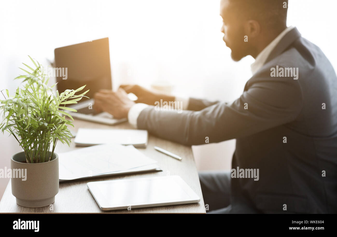 Office work background. African employee with laptop and papers Stock ...