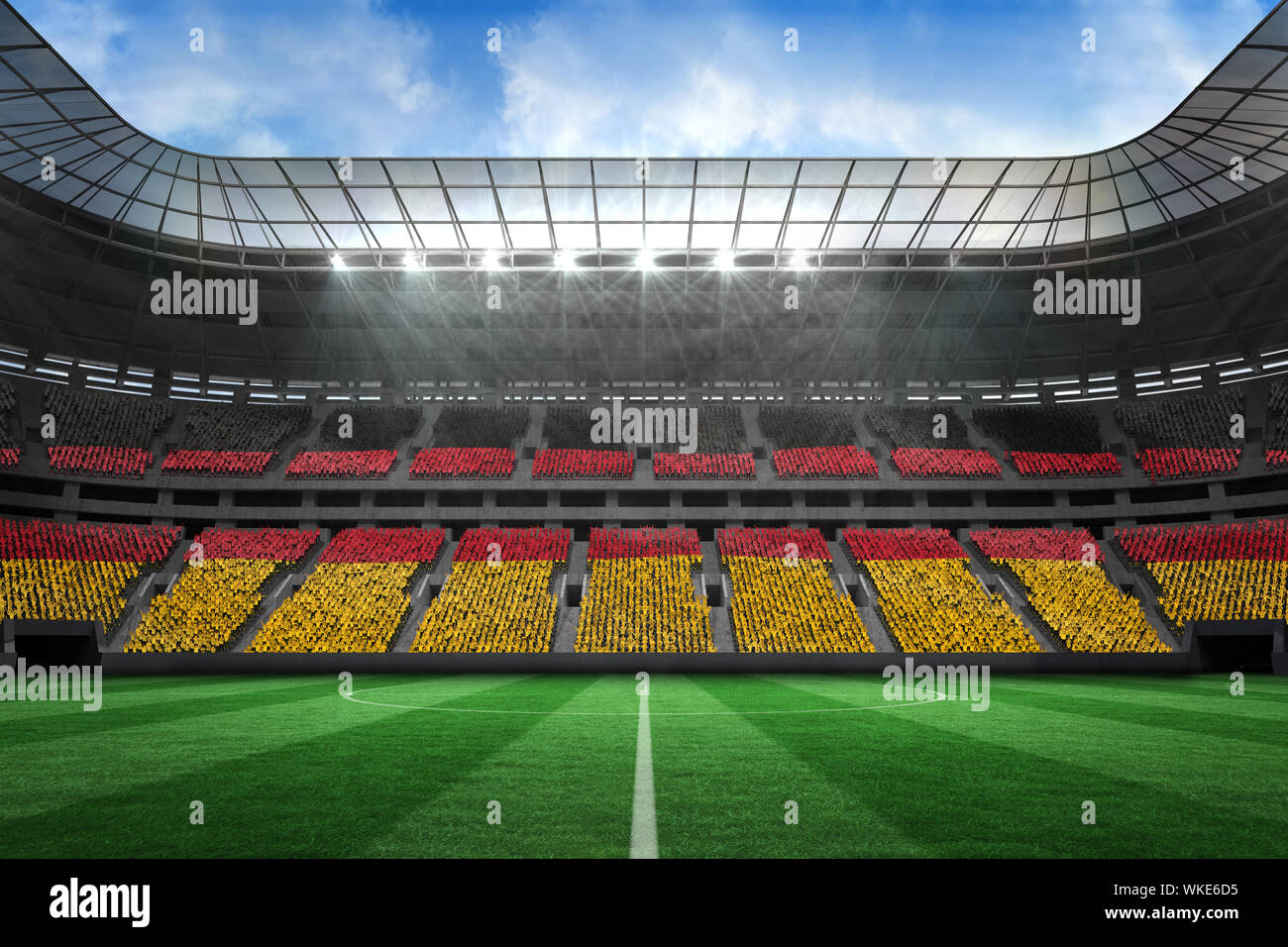 Digitally generated german national flag against large football stadium ...