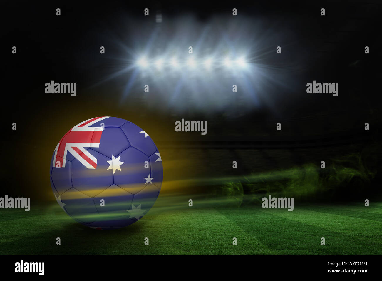 Football in australia colours against football pitch under spotlights ...