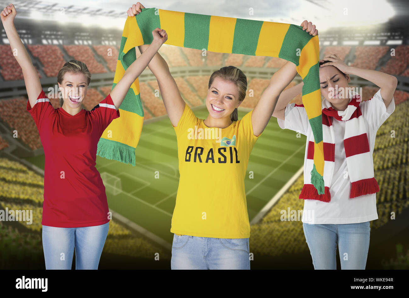 Composite image of various football fans against vast football stadium ...