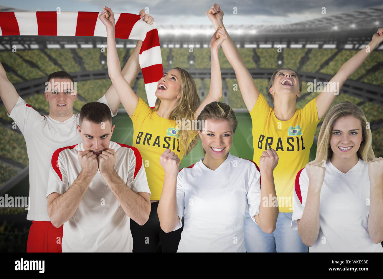Composite image of various football fans against large football stadium ...