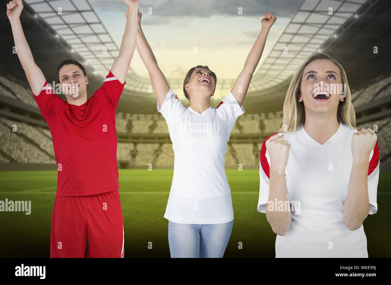Composite image of various football fans against vast football stadium ...