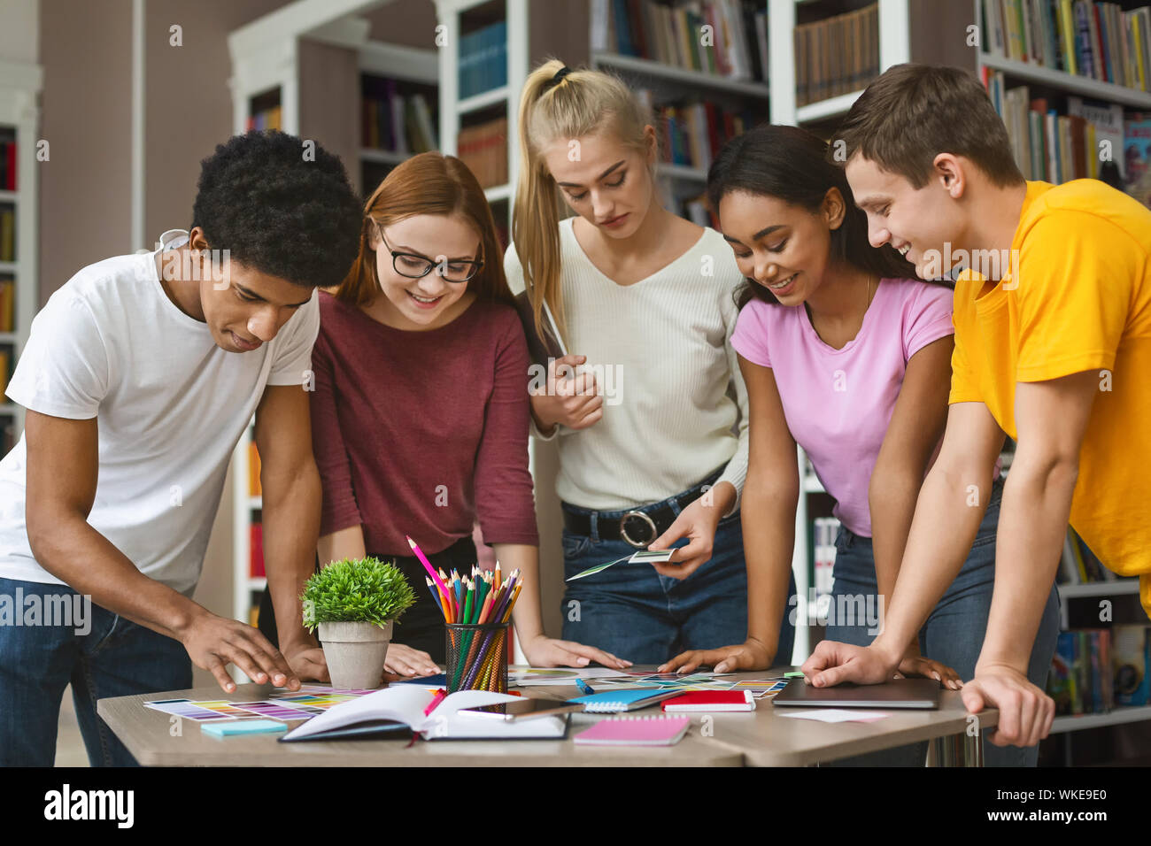 Enthusiastic students looking at color swatch samples Stock Photo - Alamy