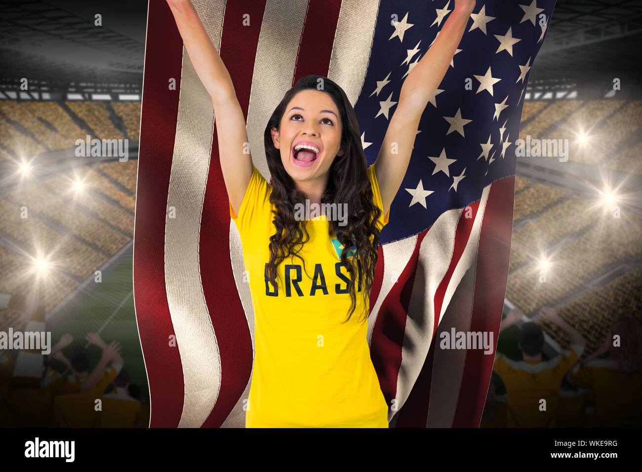 Excited football fan in brasil tshirt holding usa flag against vast ...