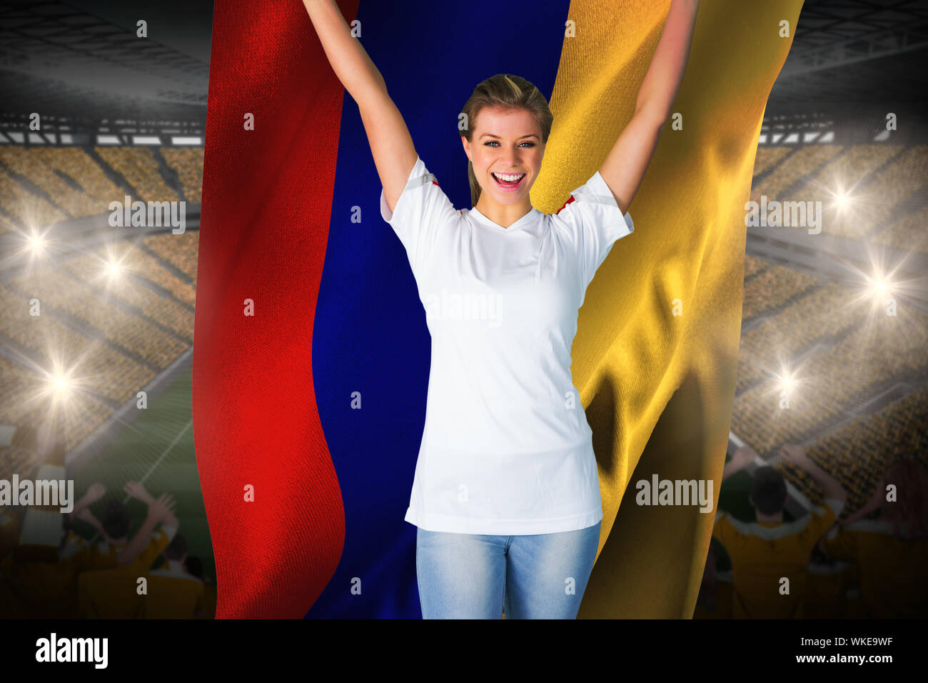 Pretty football fan in white cheering holding colombia flag against ...