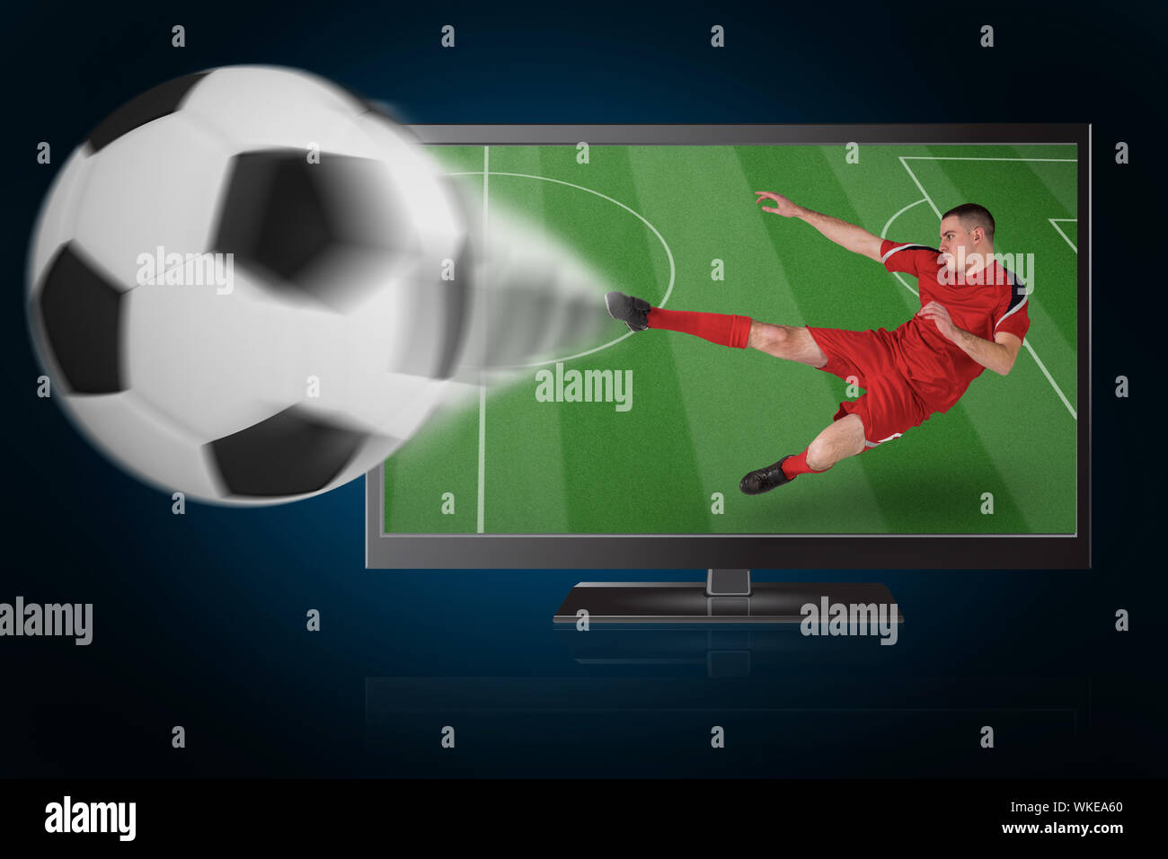 Fit football player playing and kicking ball out of tv against blue ...