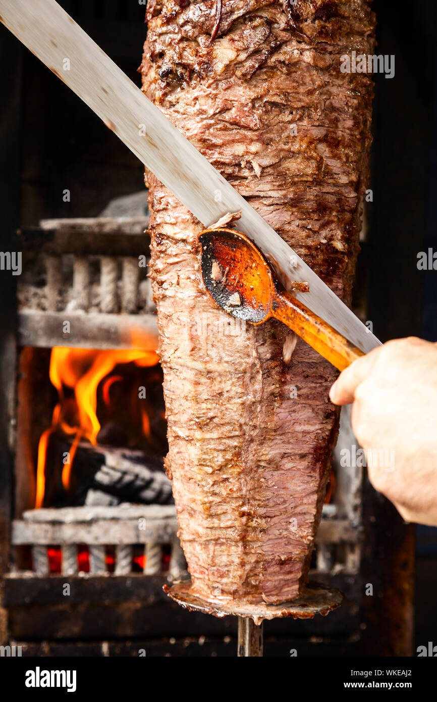 Shawarma meat being cut before making a sandwich Stock Photo - Alamy