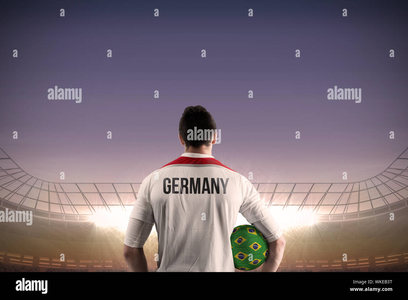 Germany football player holding ball against large football stadium ...