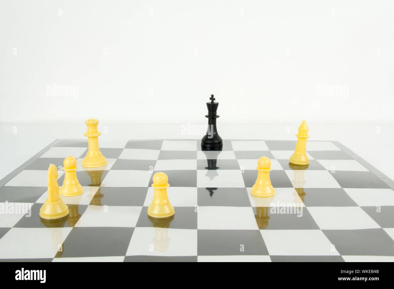 Black king being checked by white bishop on chessboard Stock Photo - Alamy