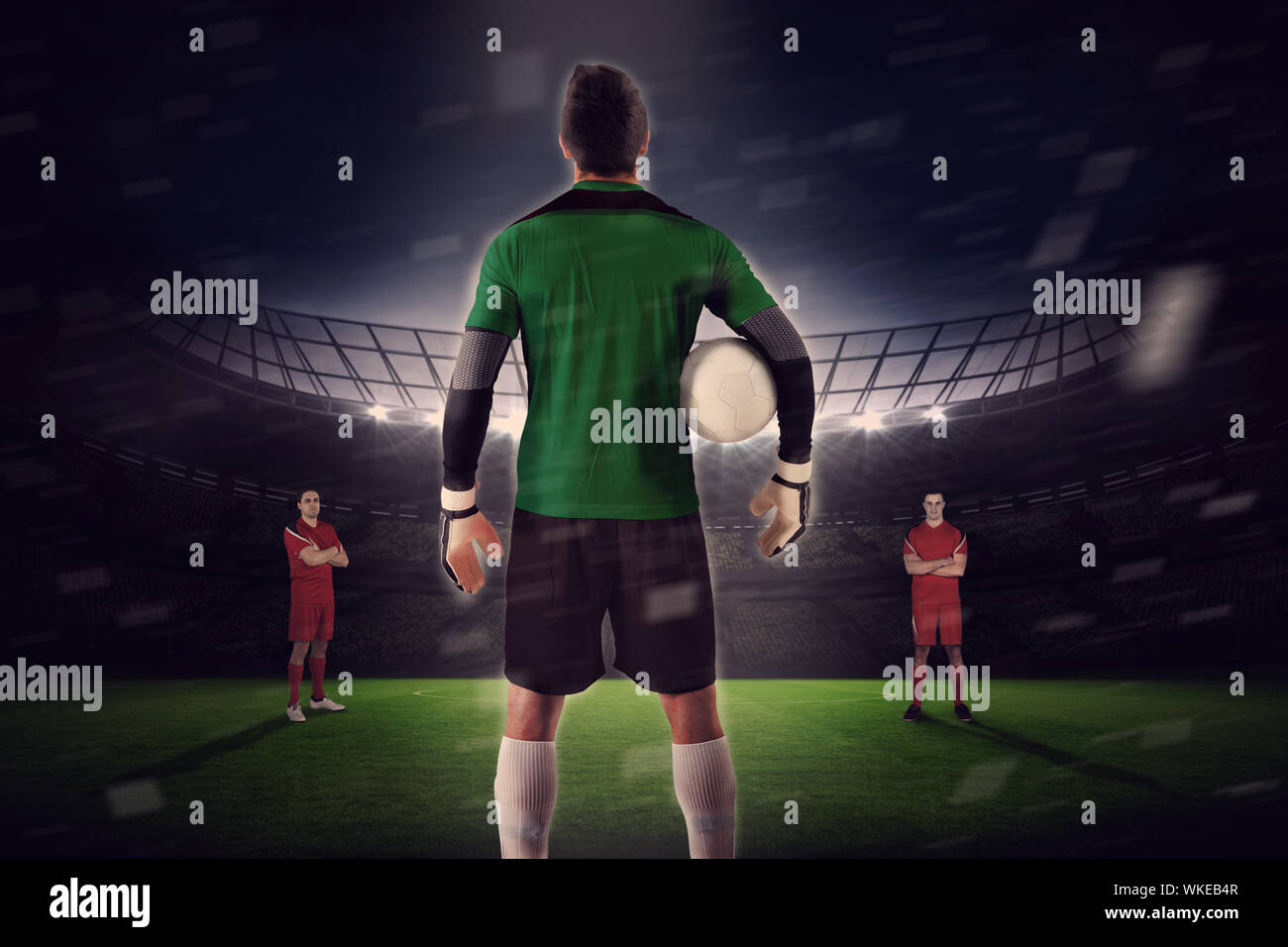 Composite image of goalie facing opposition against large football ...