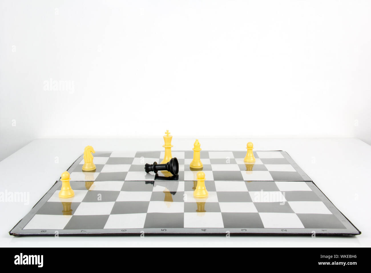 Black queen defeated by white king Stock Photo - Alamy