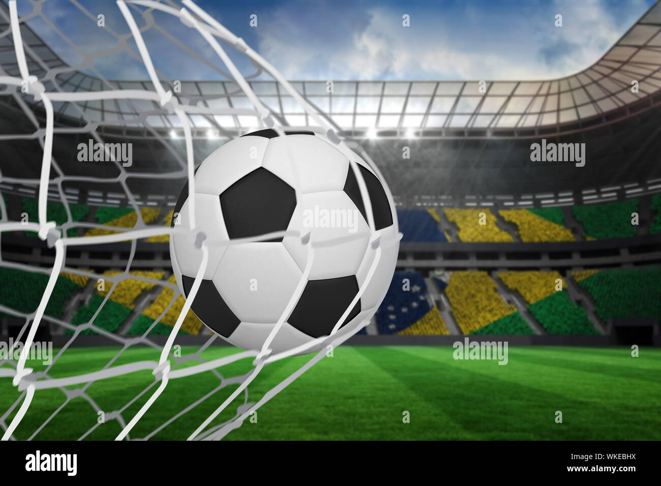 Football at back of net against large football stadium with brasilian ...