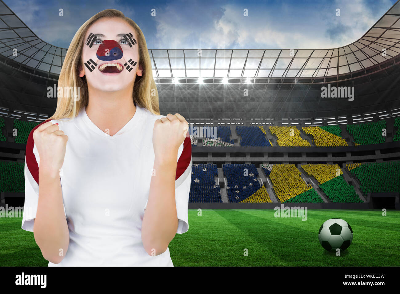 Excited south korea fan in face paint cheering against large football ...