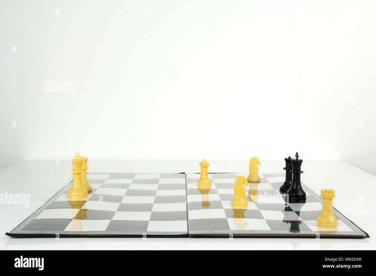 Black king being checked by white knight on chessboard Stock Photo - Alamy
