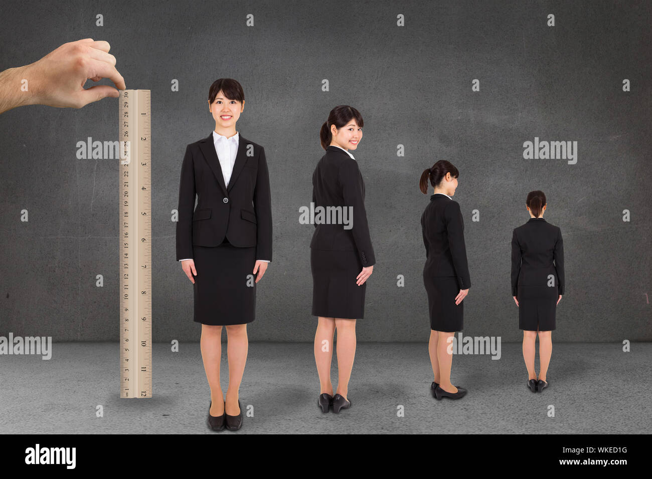 Composite image of hand measuring businesswoman with ruler against grey ...