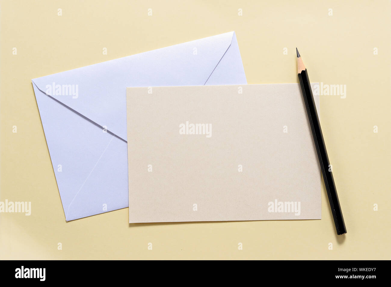 Envelope With Blank Paper And Pencil Over Beige Background Stock Photo ...