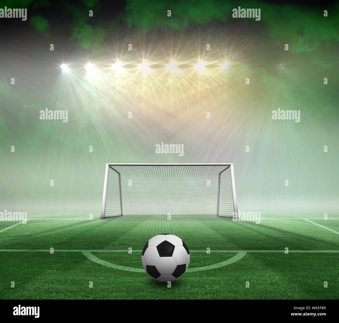 Black and white football against football pitch and goal under ...