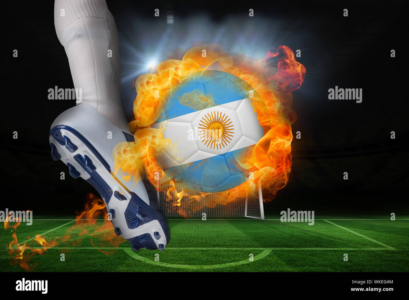 Football player kicking flaming argentina flag ball against football ...
