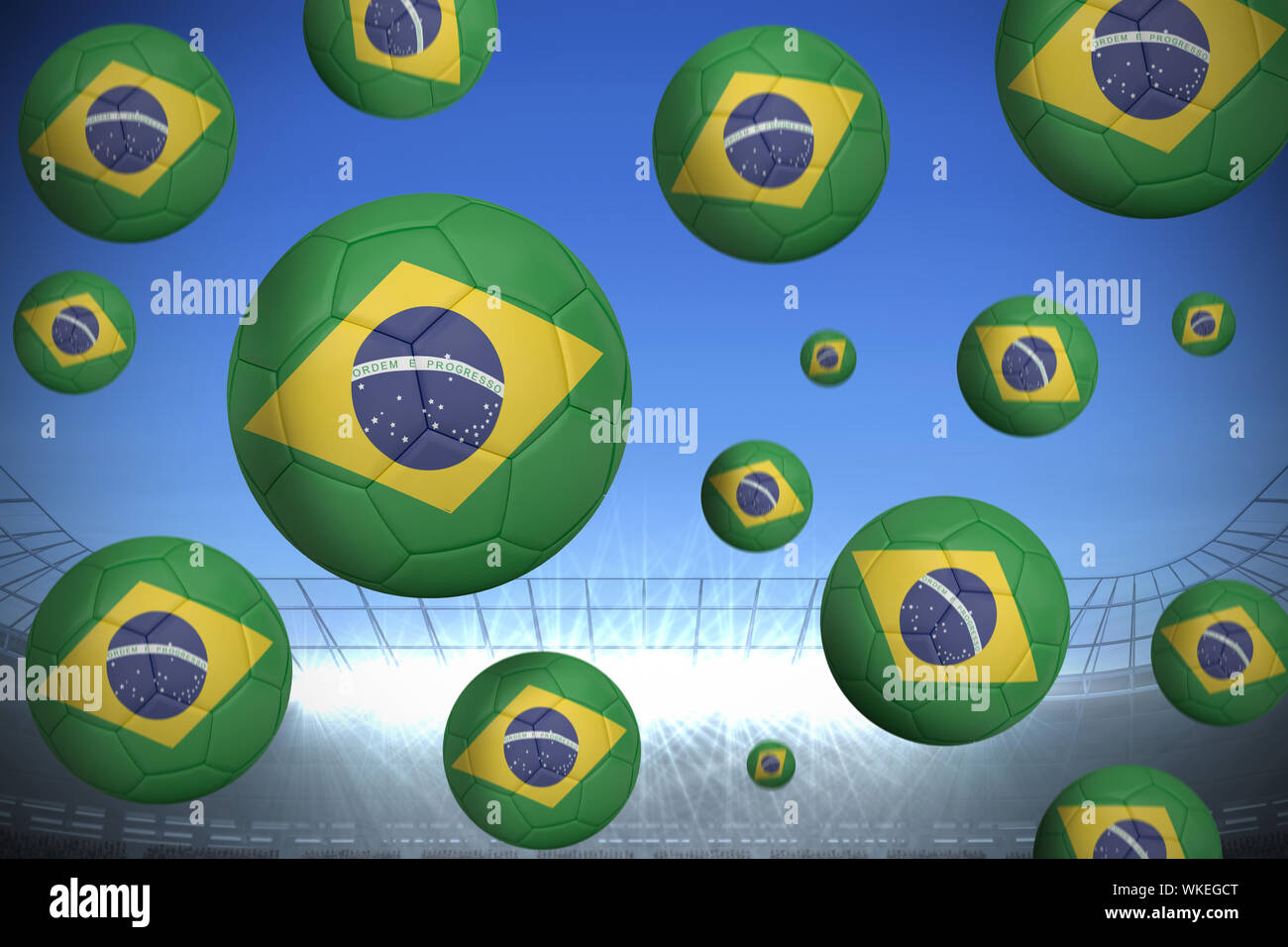 Footballs in brasil flag colours against large football stadium under ...