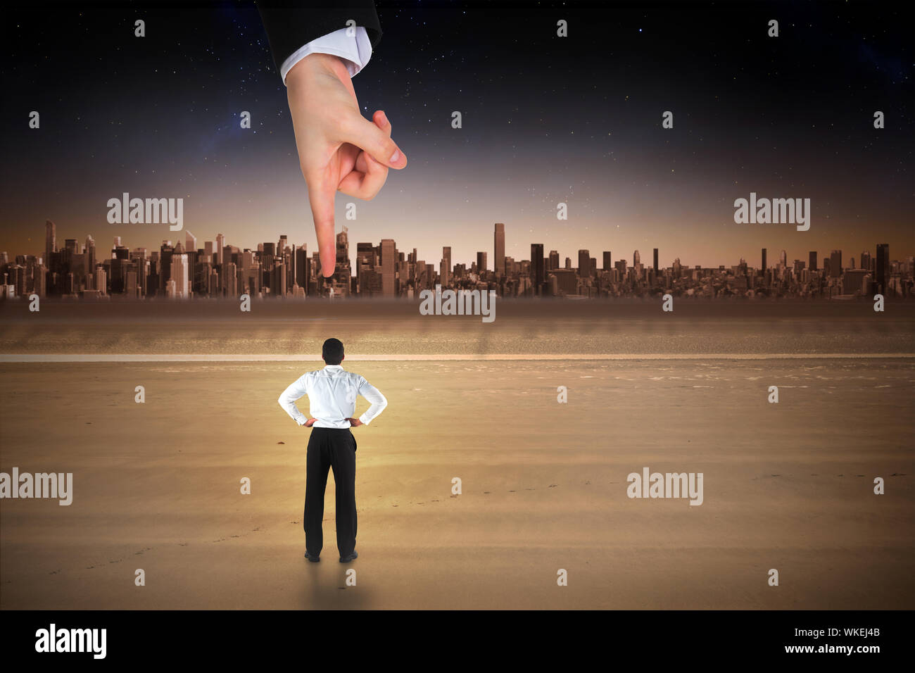Giant hand pointing at businessman standing back to the camera with ...