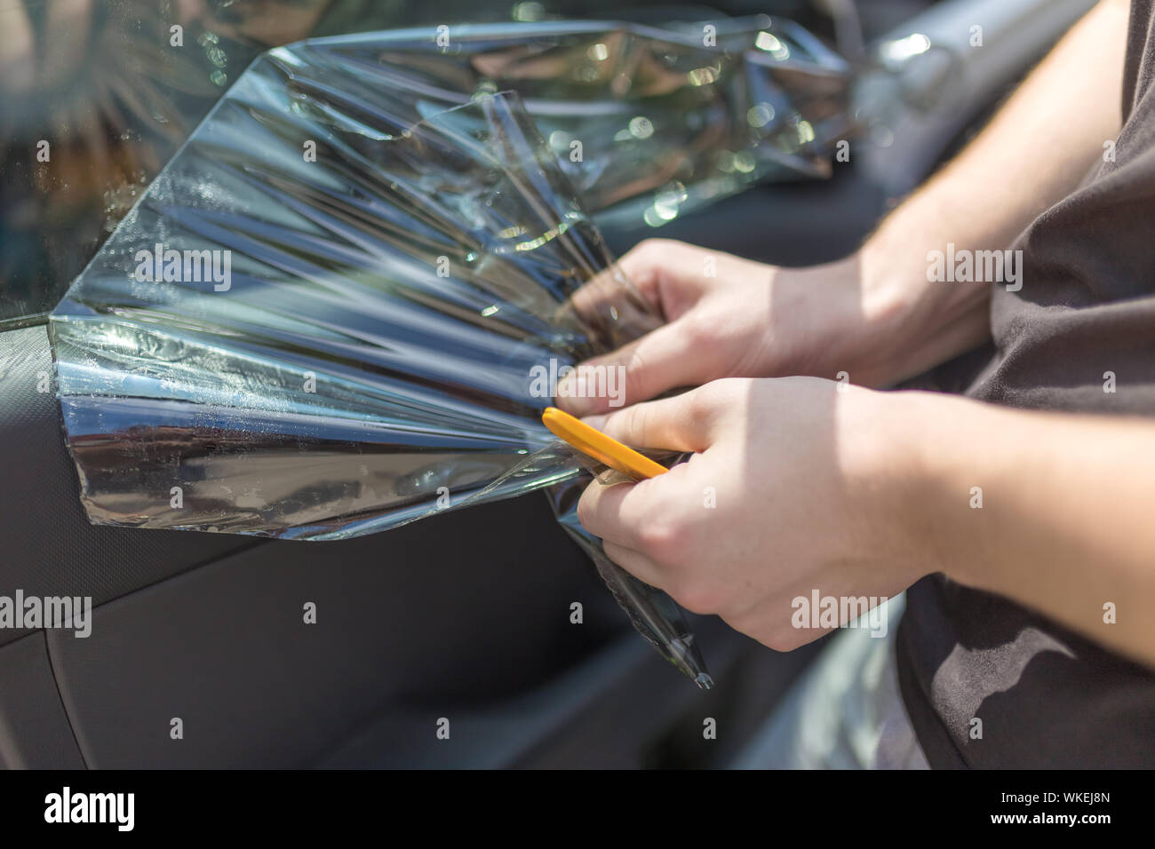 Process of removing sunlight protective car window glass foil Stock ...