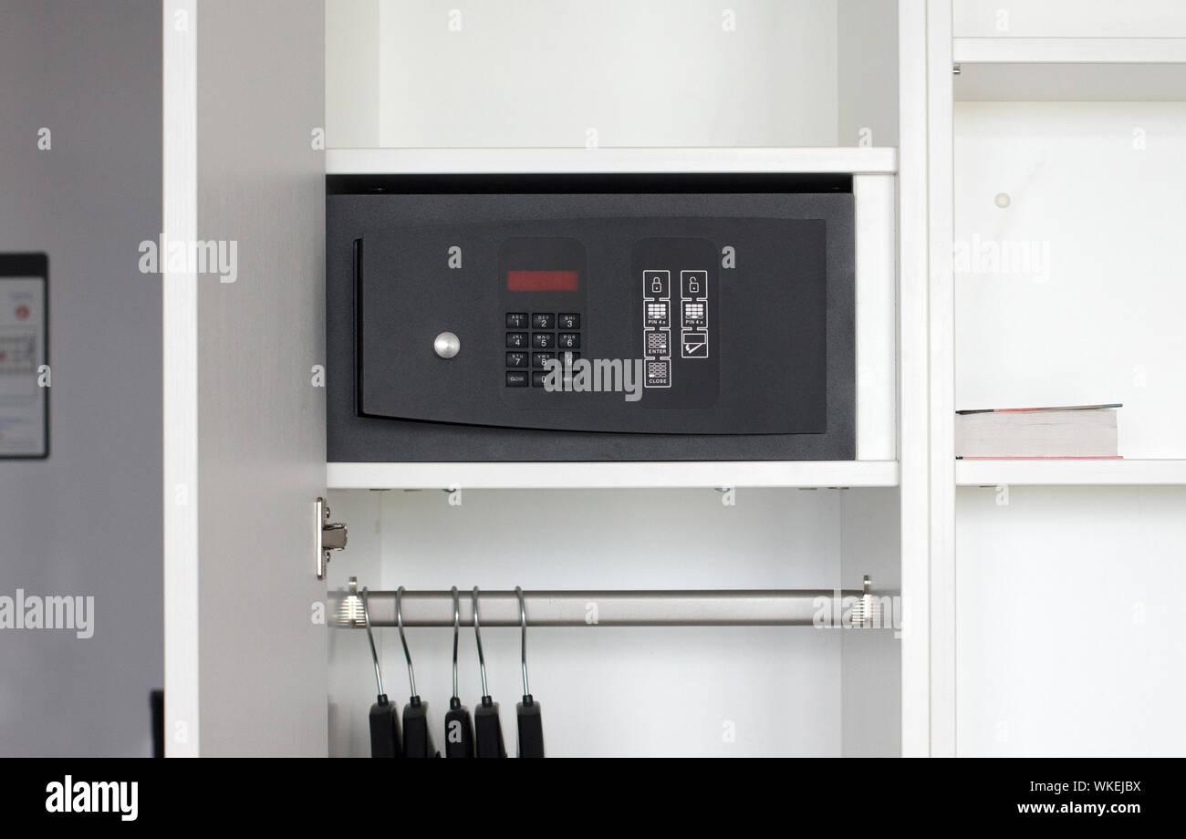 Safe box in a hotel room, white closet Stock Photo - Alamy