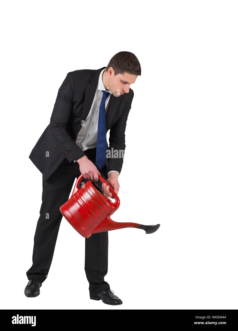 Businessman watering with red can on white background Stock Photo - Alamy