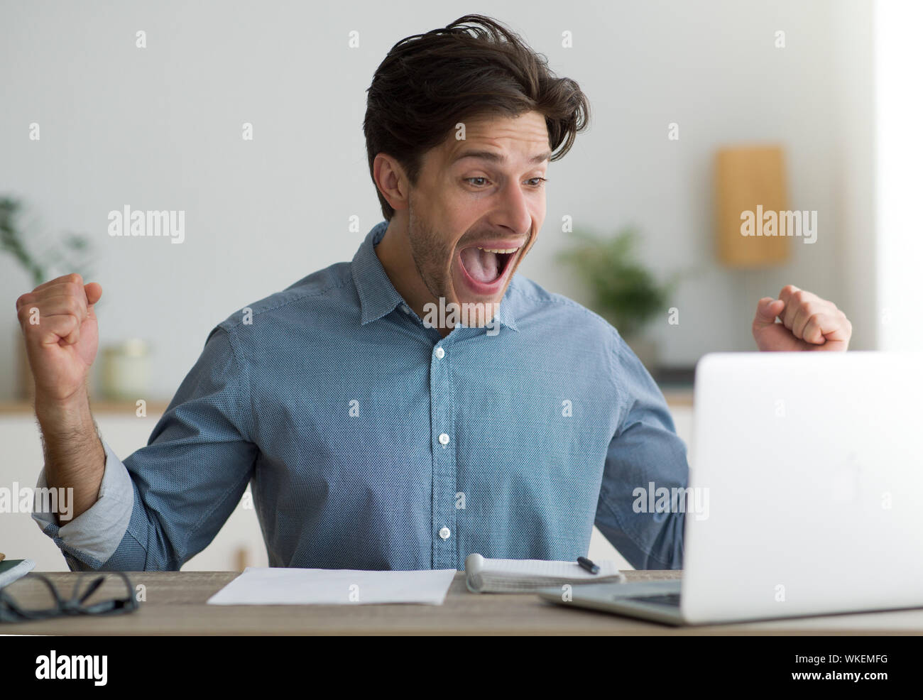Guy Celebrating Success At Laptop Shaking Fists At Workplace Stock ...