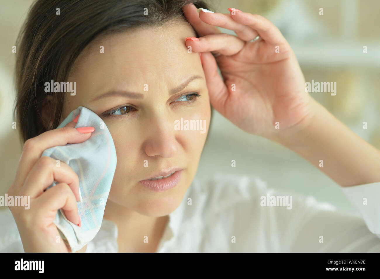 Beautiful young crying woman posing at home Stock Photo - Alamy