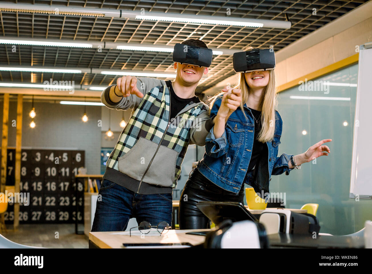 young Caucasian people man and woman wear virtual reality glasses. best ...