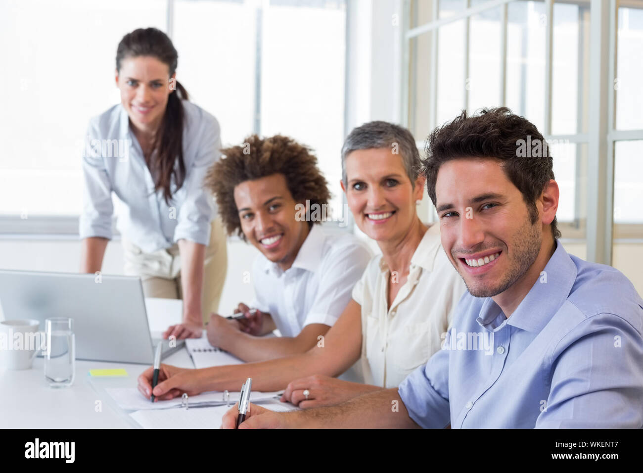 Casual staff smiling at camera in the office Stock Photo - Alamy