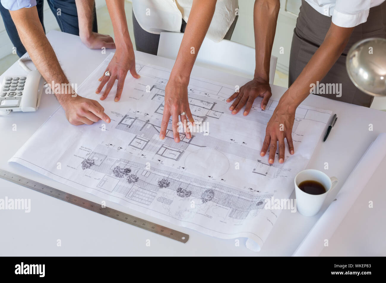 Architects looking at building plans carefully in the office Stock ...