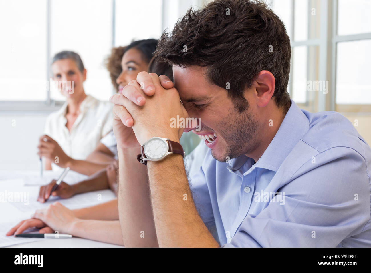 Business people laughing during a meeting in the office Stock Photo - Alamy
