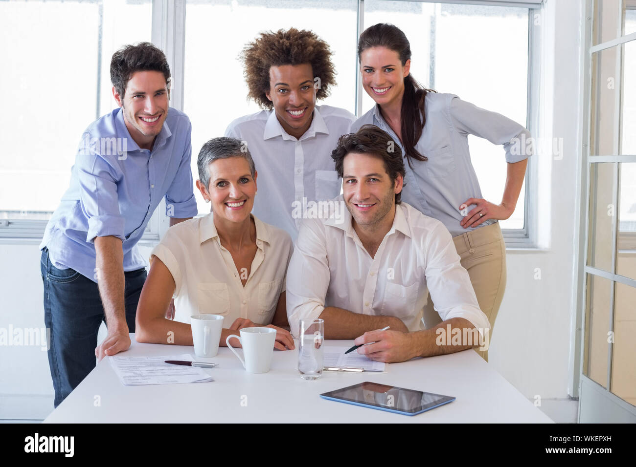 Attractive business people smiling and working together Stock Photo - Alamy