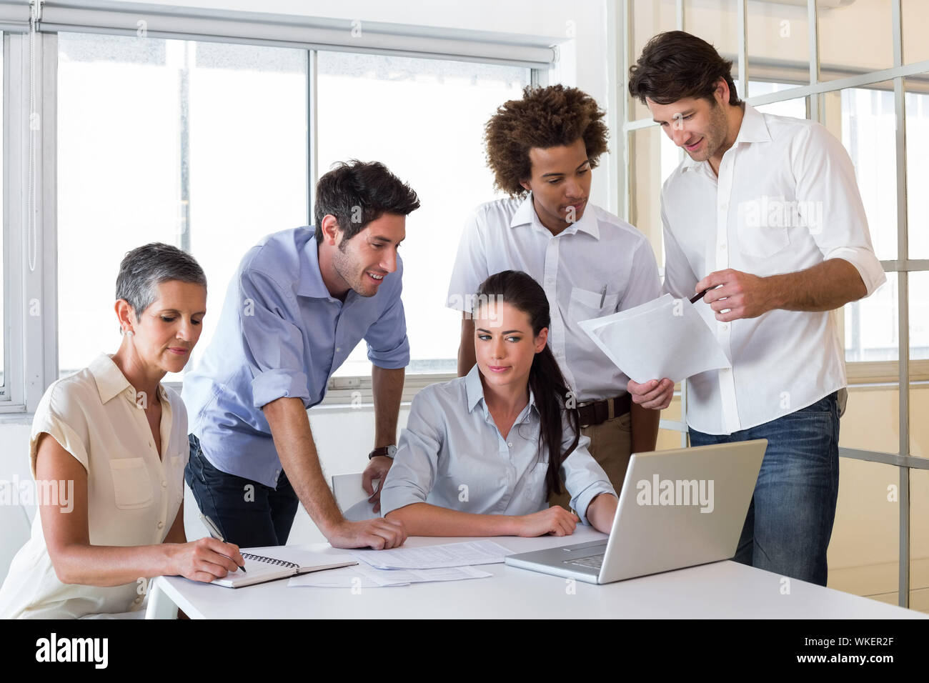Attractive business people working hard together in the workplace Stock ...