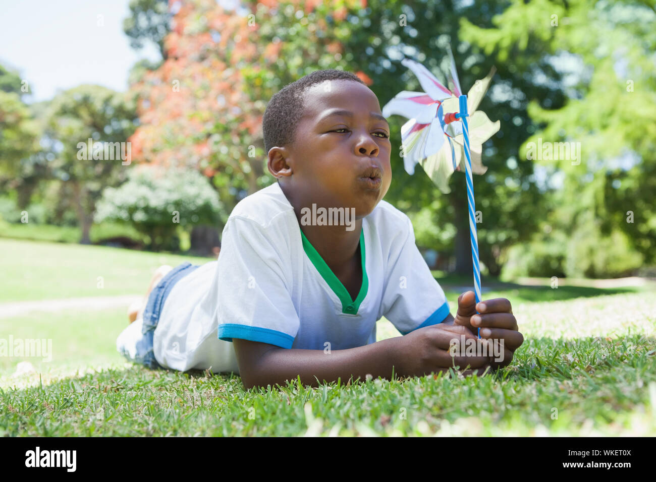 Little boy blowing pinwheel in the park on a sunny day Stock Photo - Alamy