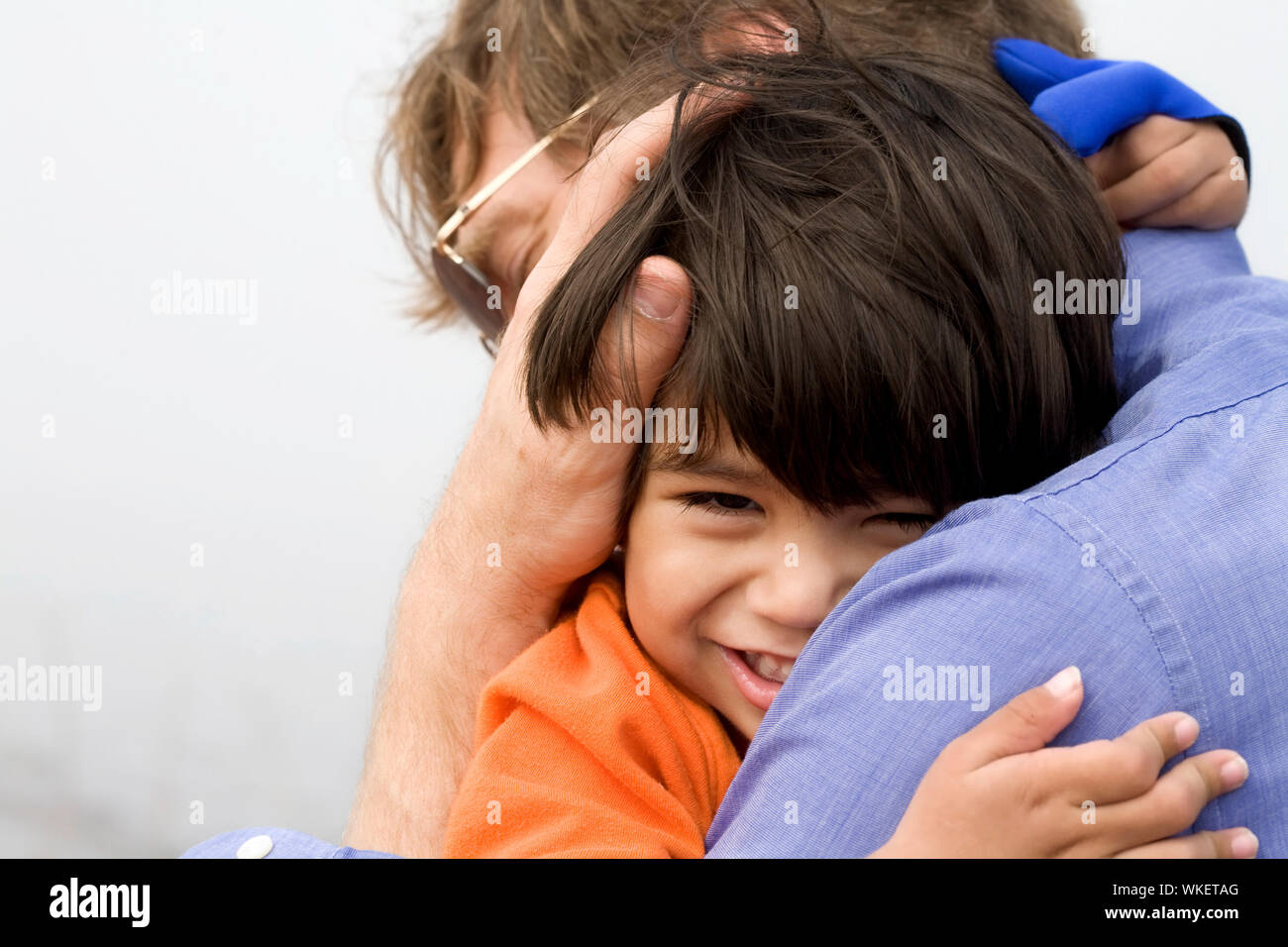 Little boy giving his father a big hug Stock Photo - Alamy