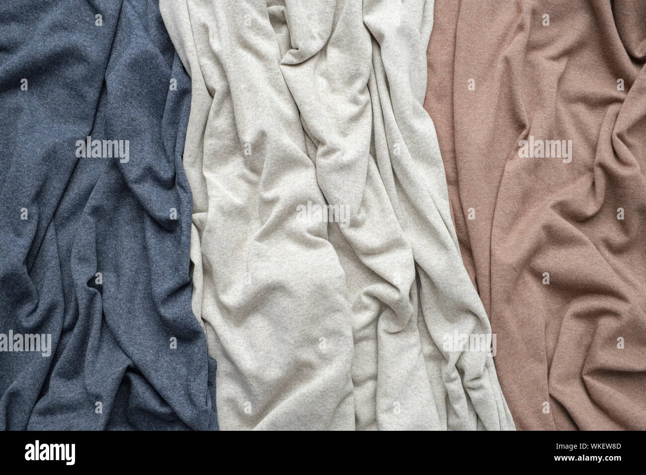 Knitted indigo, beige and brown fabrics, draped jersey cloths ...