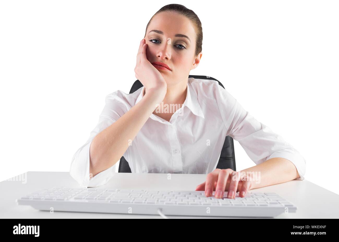 Bored businesswoman typing on keyboard on white background Stock Photo ...