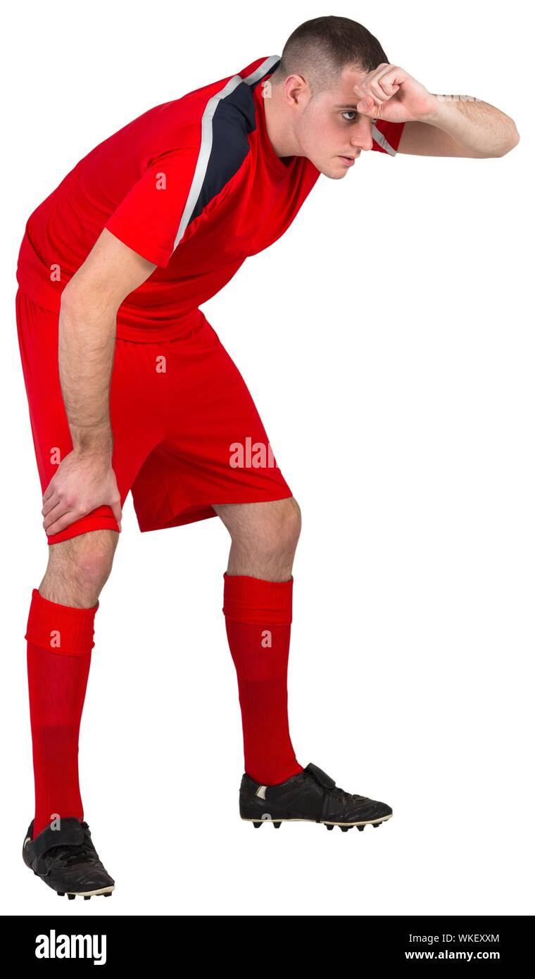 Tired football player bending over on white background Stock Photo - Alamy