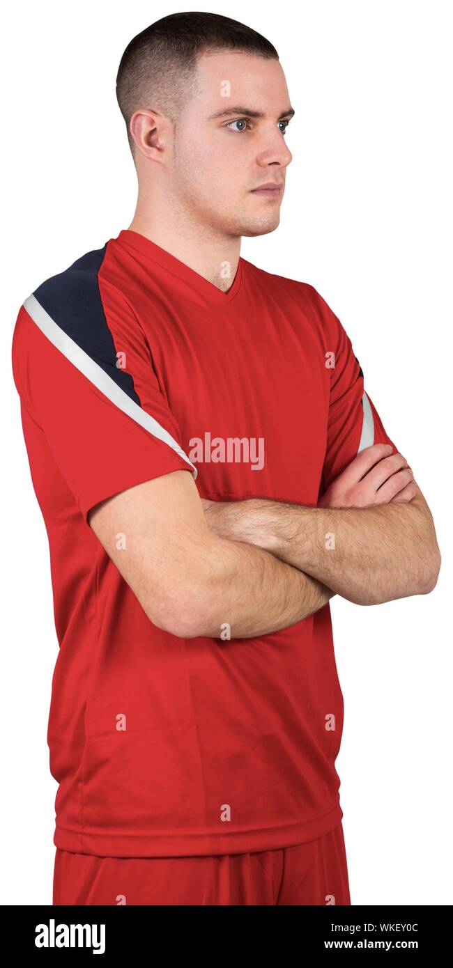 Fit football player standing with arms crossed on white background ...