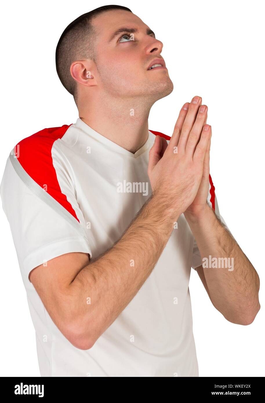 Nervous football player looking up on white background Stock Photo - Alamy