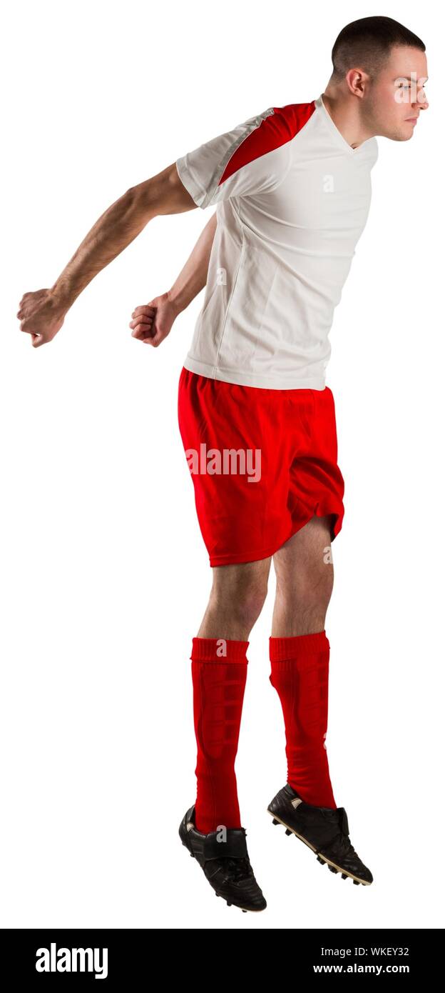Fit football player jumping up on white background Stock Photo - Alamy