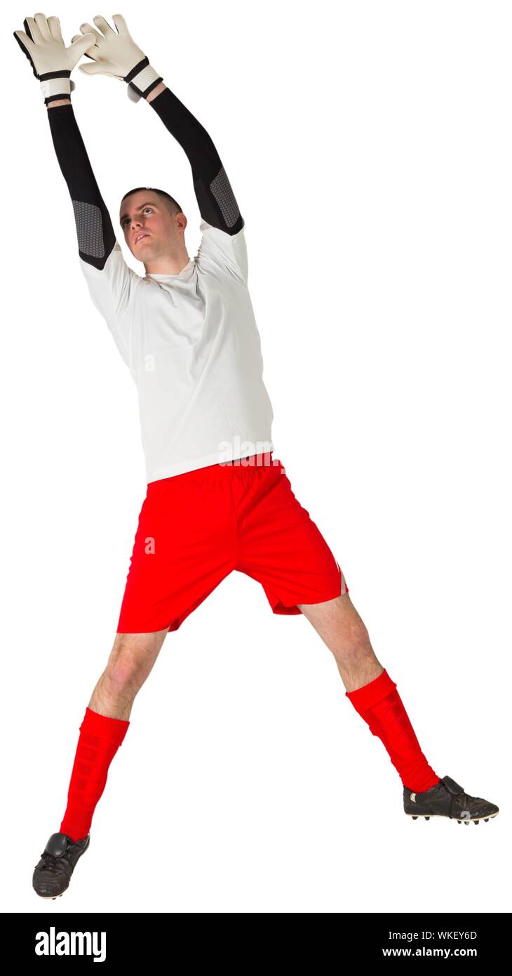 Fit goal keeper jumping up on white background Stock Photo - Alamy